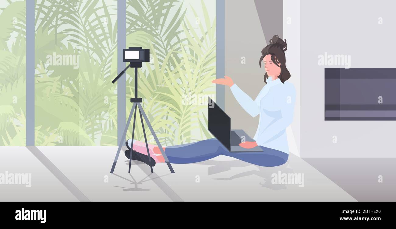 woman blogger recording video blog using camera on tripod live ...