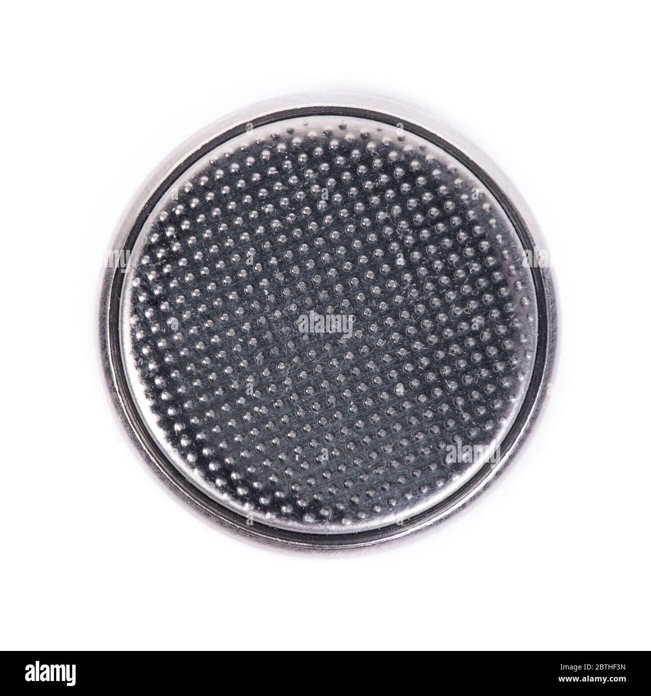 Flat lithium round button cell battery isolated over white background ...