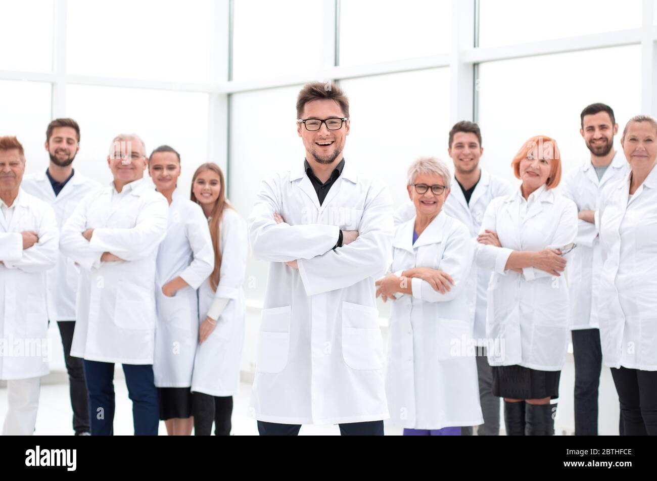 confident scientific leader standing in front of a team of young ... confident scientific leader standing in front of a team of young ...