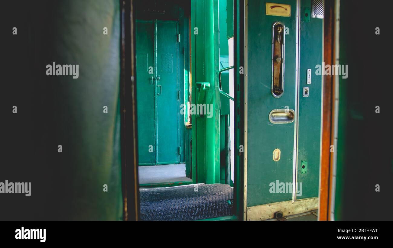 Toned image of open doors in corridor of vintage steam express trian ...