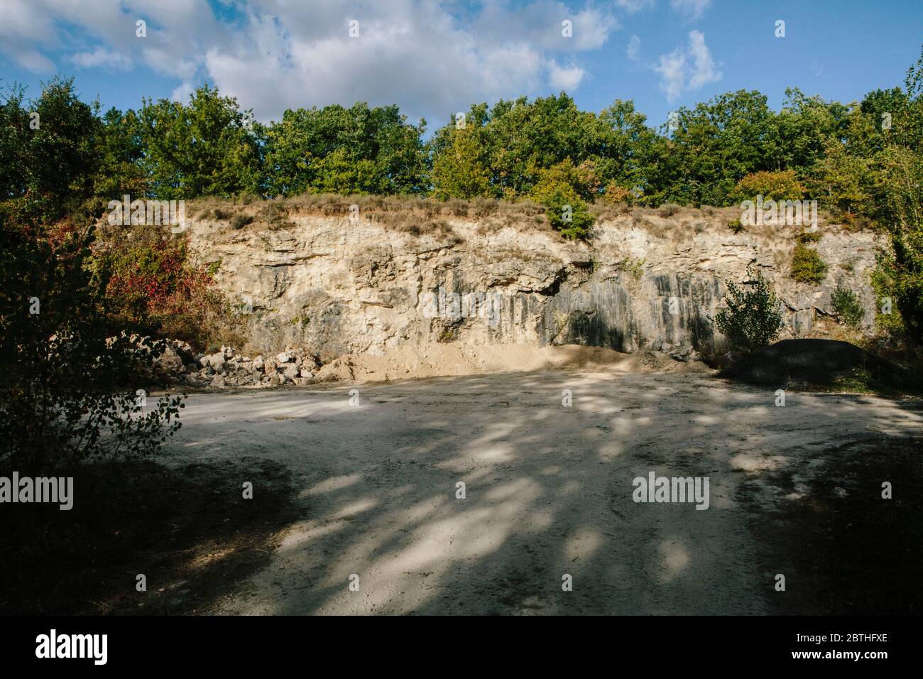 quarry, unused industrial space in wooded area Stock Photo - Alamy