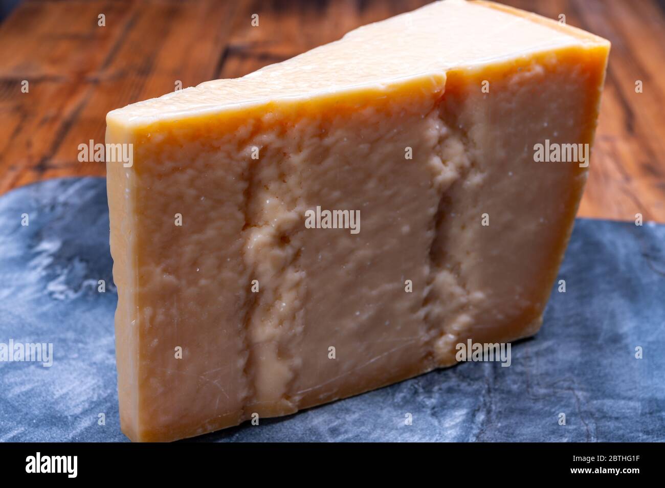 Big wedge of parmigiano-reggiano parmesan hard Italian cheese made from ...