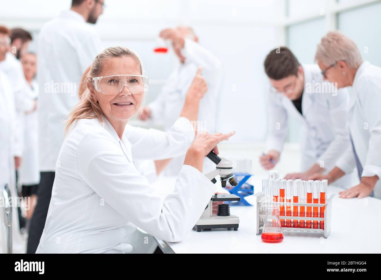 female scientist sitting at a Desk in the laboratory Stock Photo - Alamy