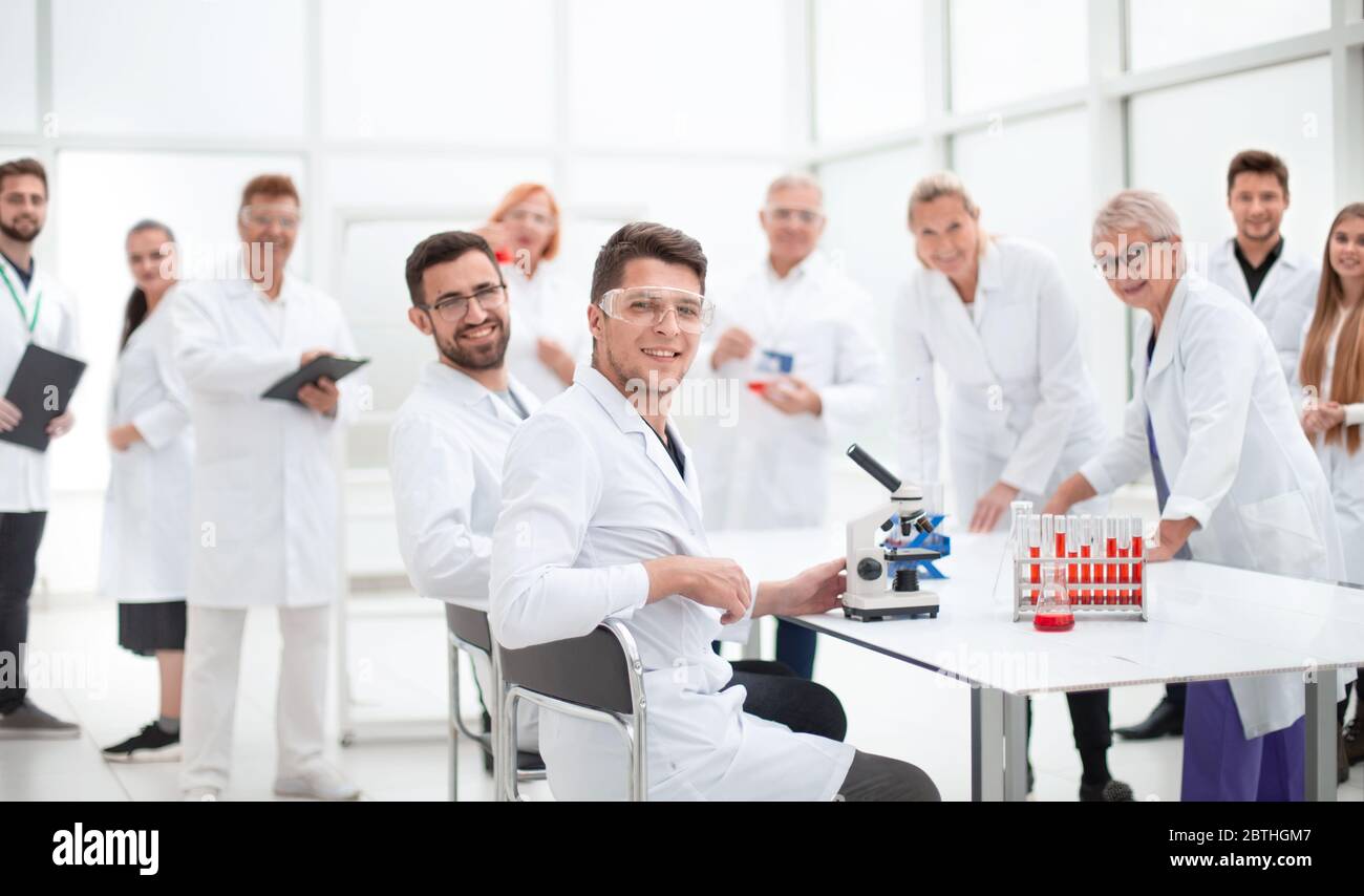 young scientist and his colleagues work in the laboratory Stock Photo ...
