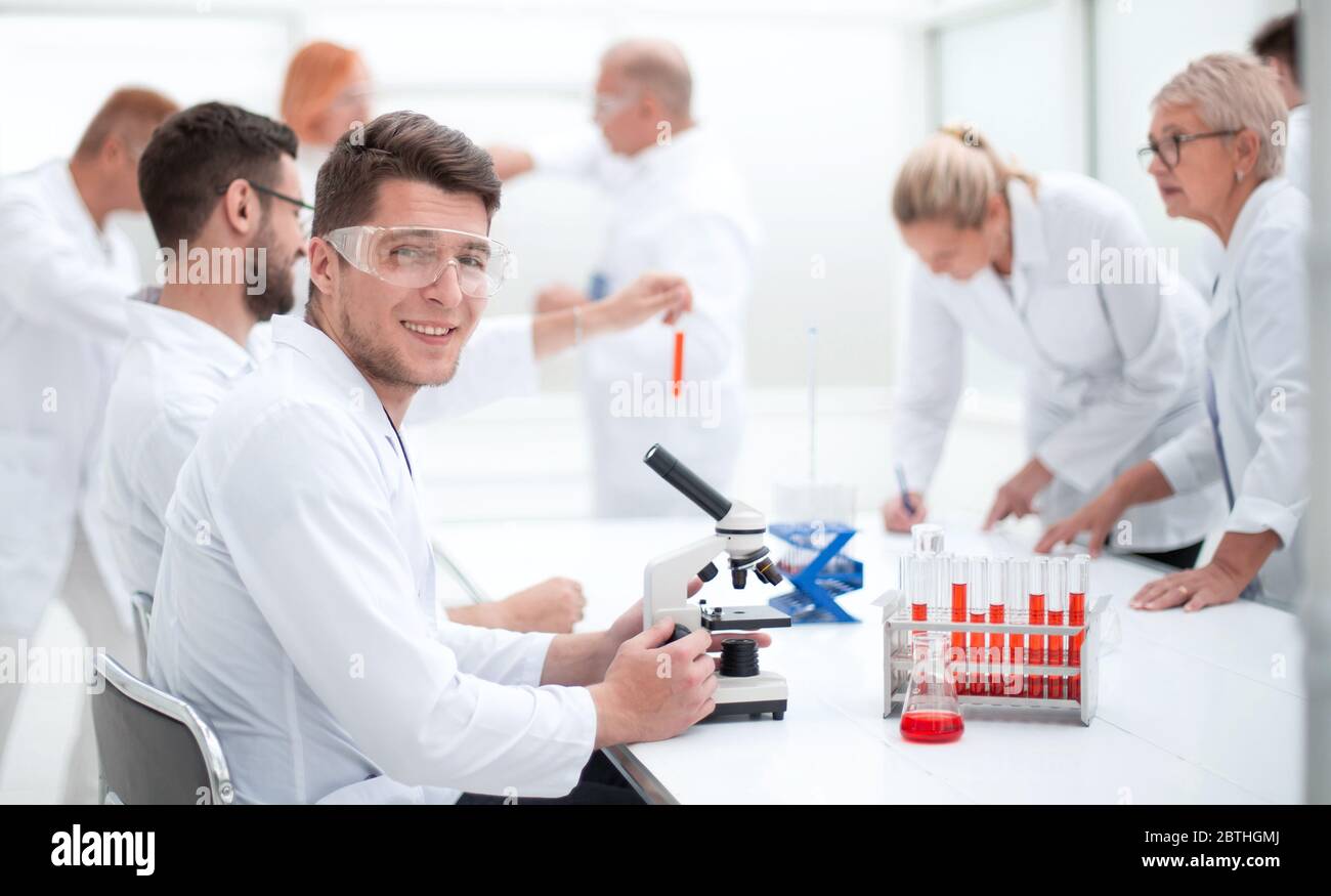 young scientist and his colleagues work in the laboratory Stock Photo ...