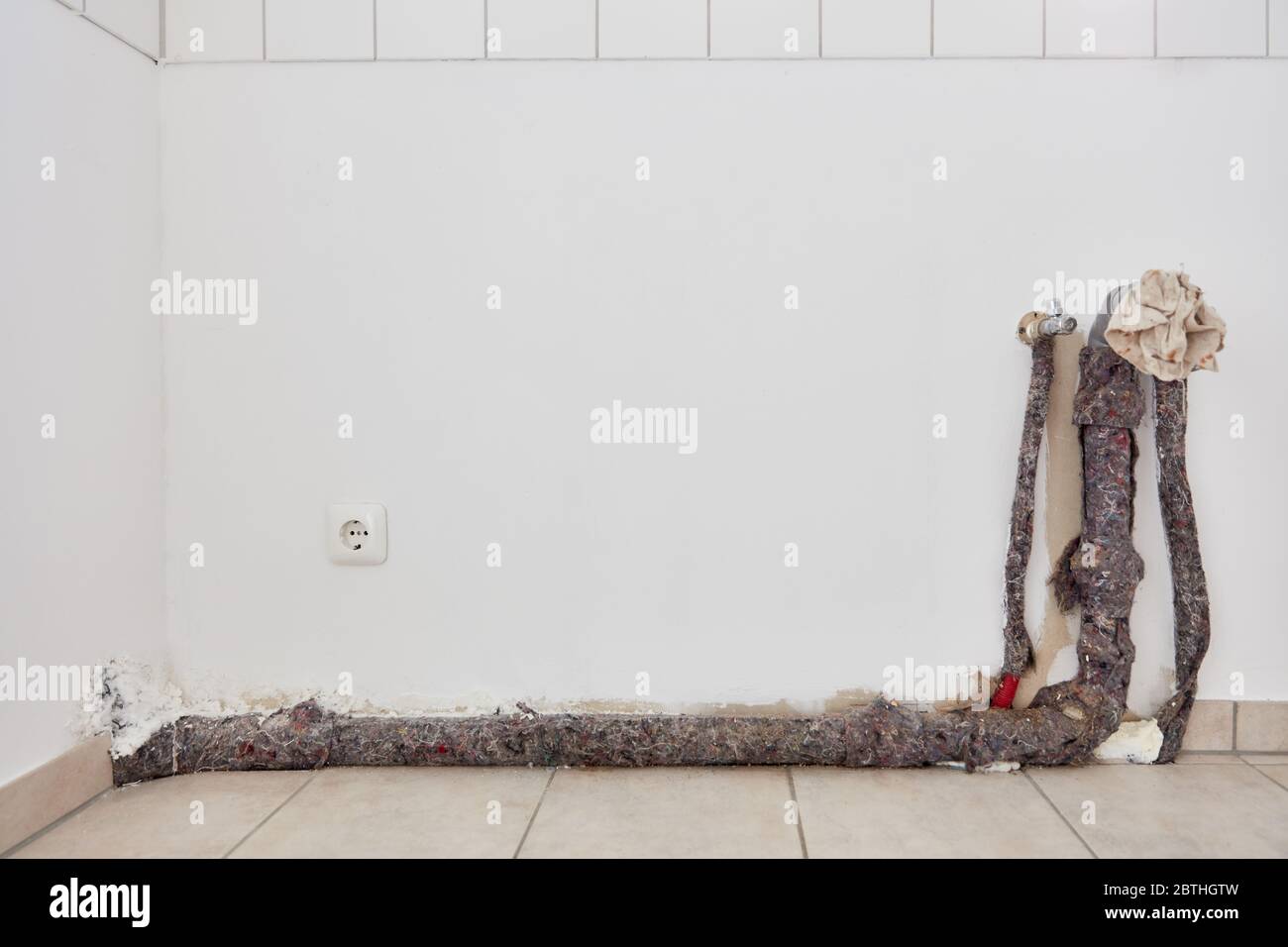 Pipe from water connection on wall in kitchen with outlet at home Stock ...