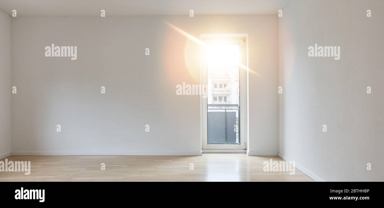 Empty sunny bright room as living room with balcony Stock Photo - Alamy