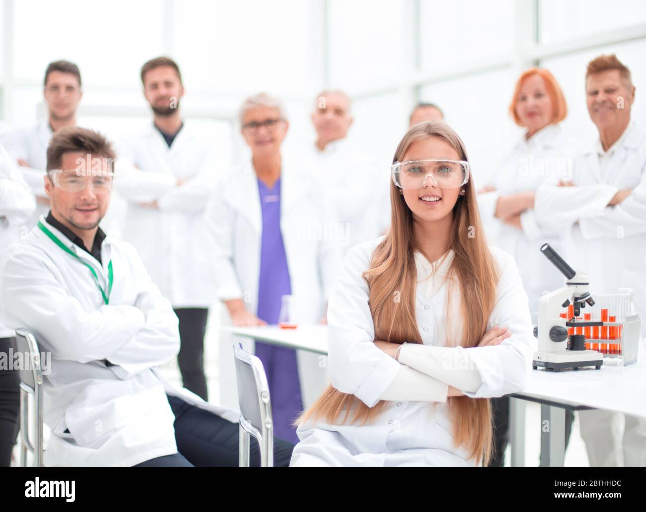 young researcher and his colleagues in the workplace Stock Photo - Alamy