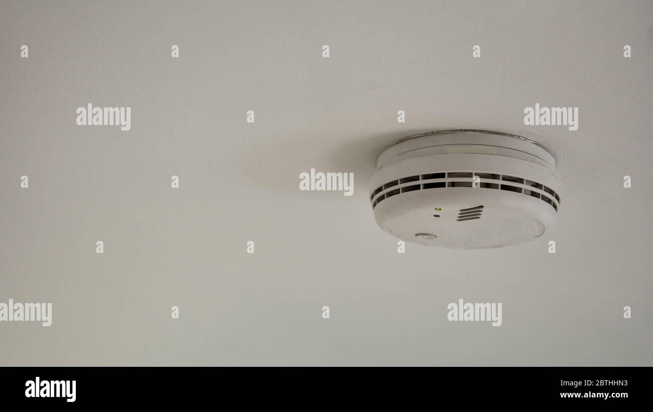 Smoke detector on ceiling in office or apartment for fire prevention ...