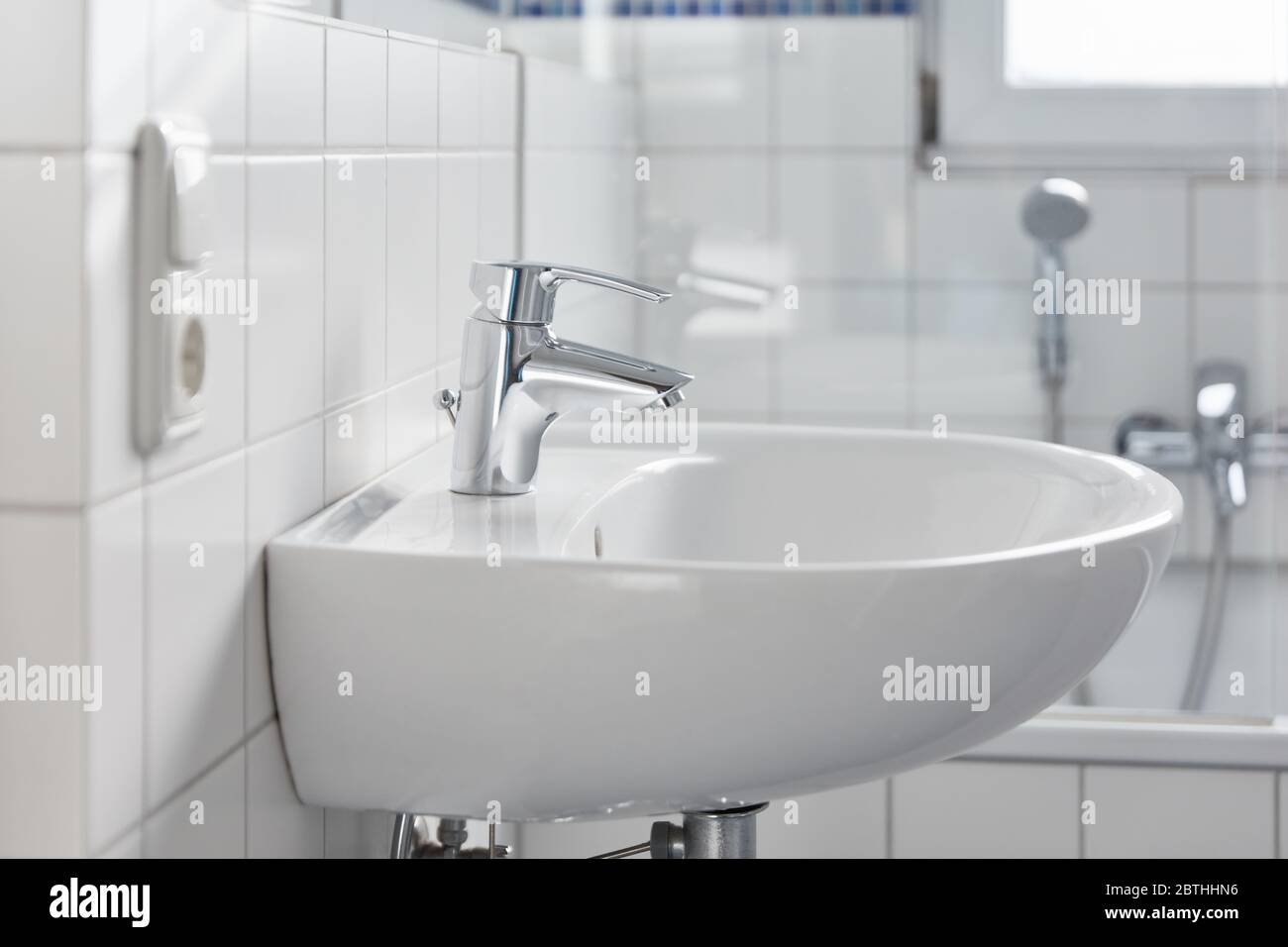 Clean sink with faucet in white bathroom at home Stock Photo - Alamy