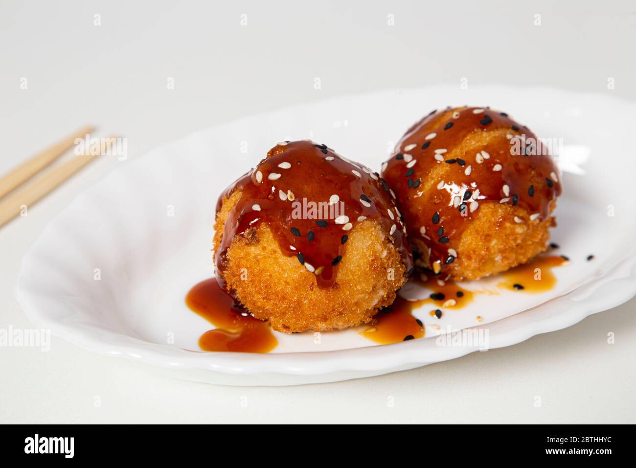 Rice balls and fried cream cheese with Teriyaki sauce and sesame ...