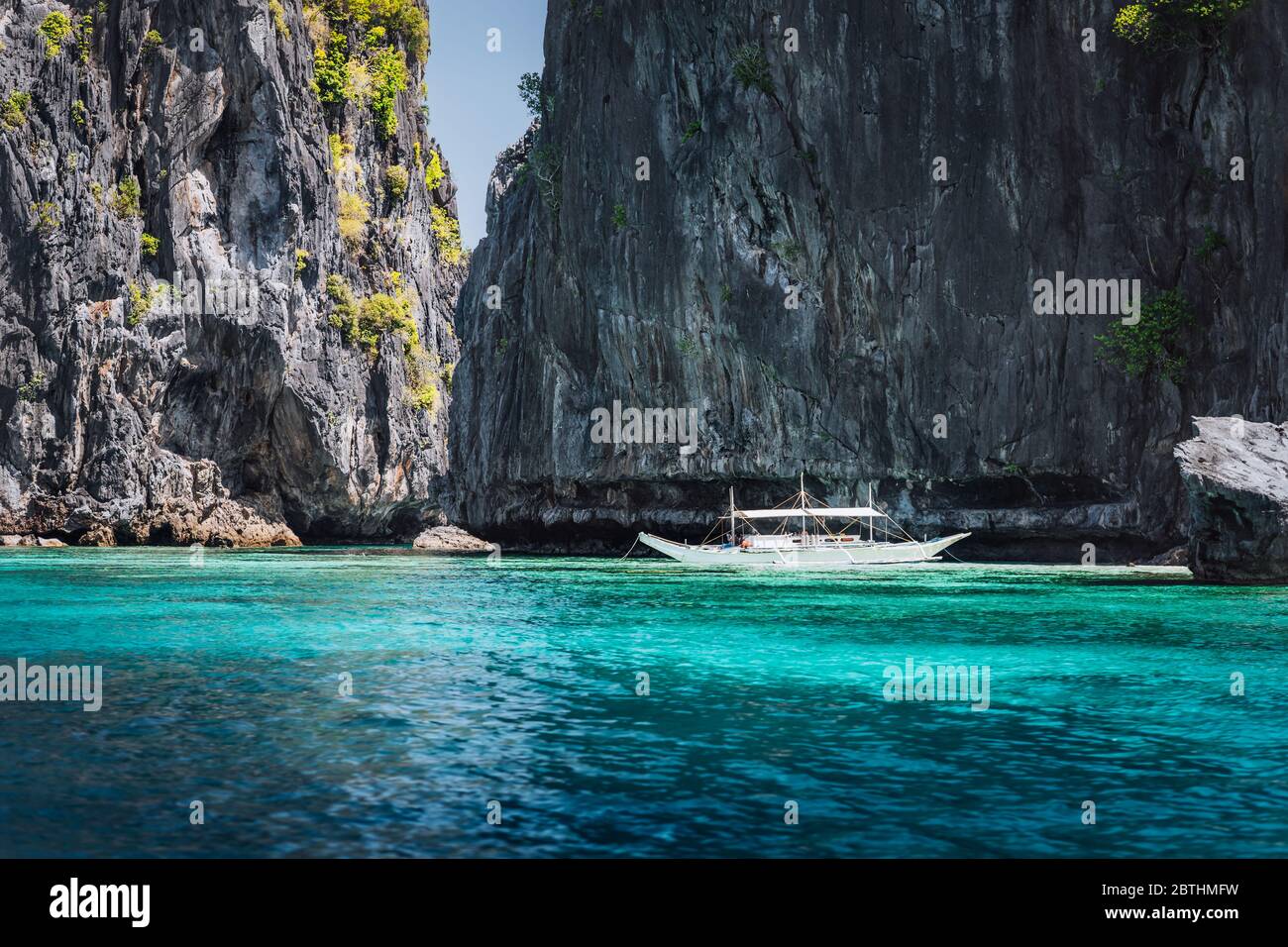 El Nido, Palawan, Philippines. Rock formation and tourism boat in ocean ...