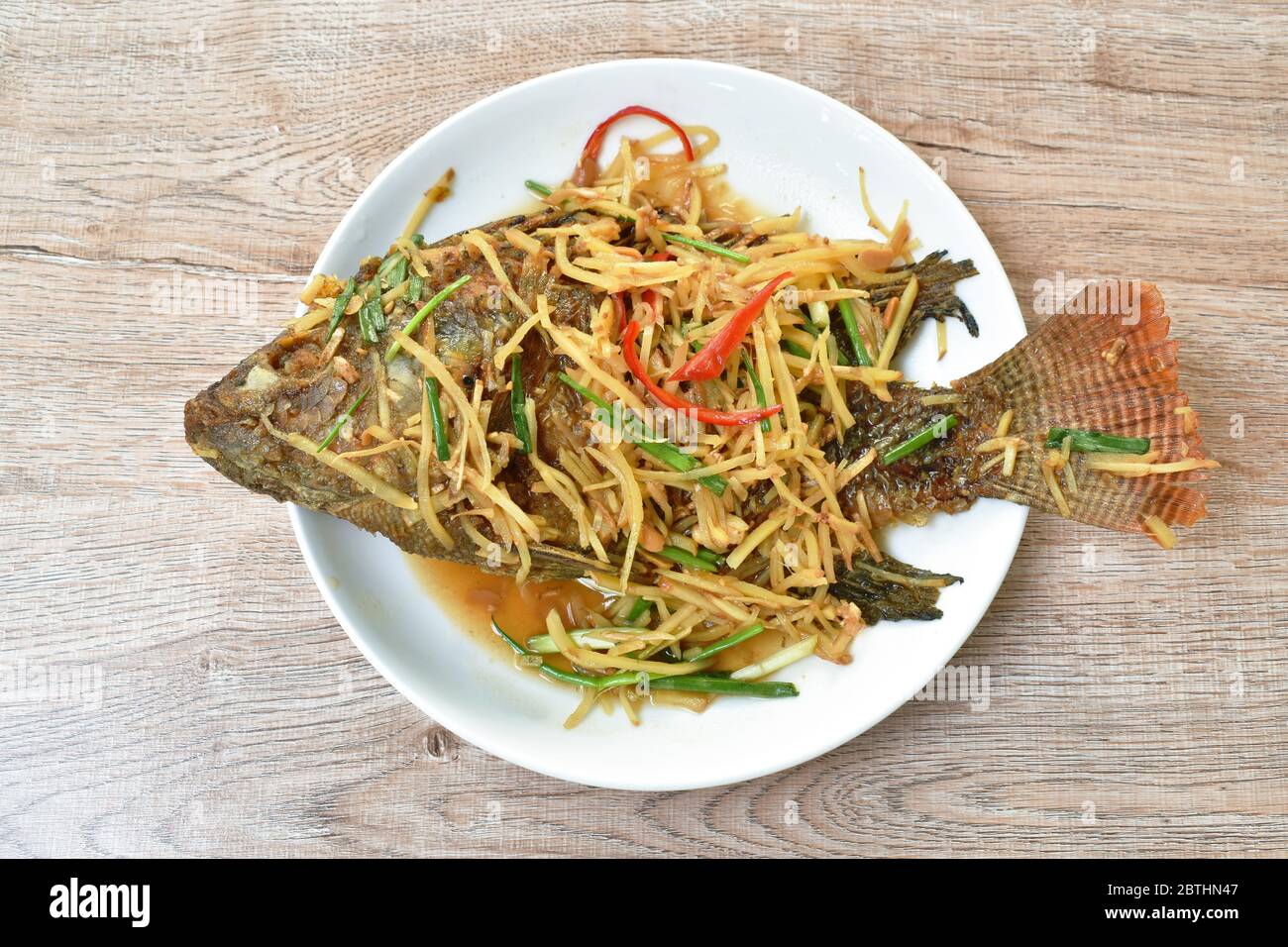 deep fried Nile Tilapia or mango fish slice dressing soy sauce and ...
