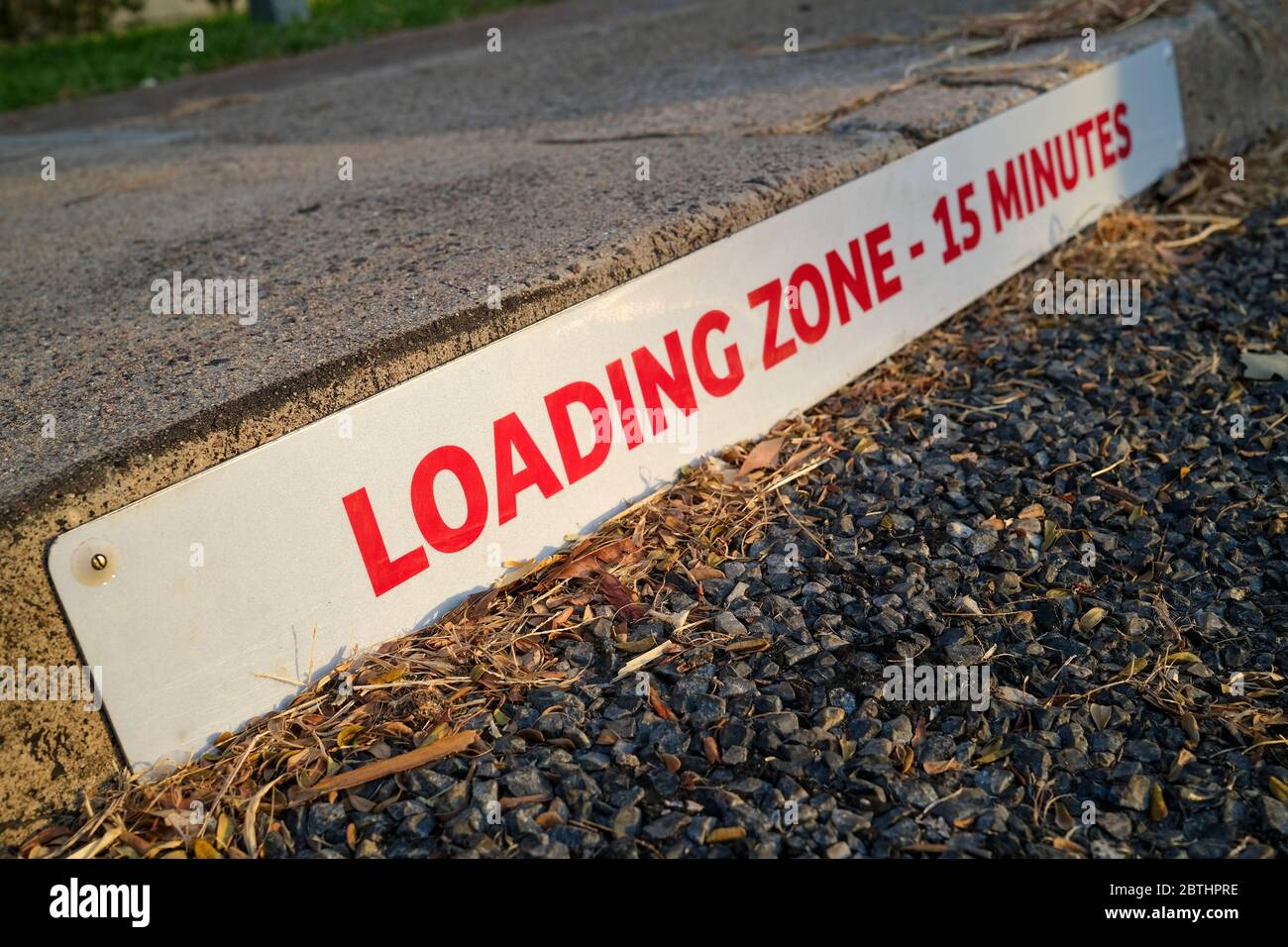 Loading zone sign on the footpath Stock Photo - Alamy