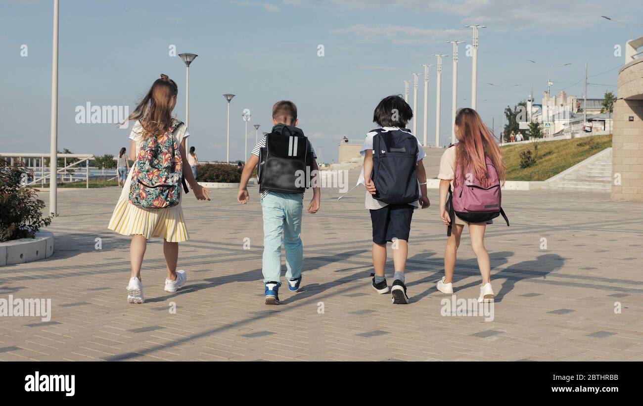 School kids walking with backpacks Stock Photo - Alamy