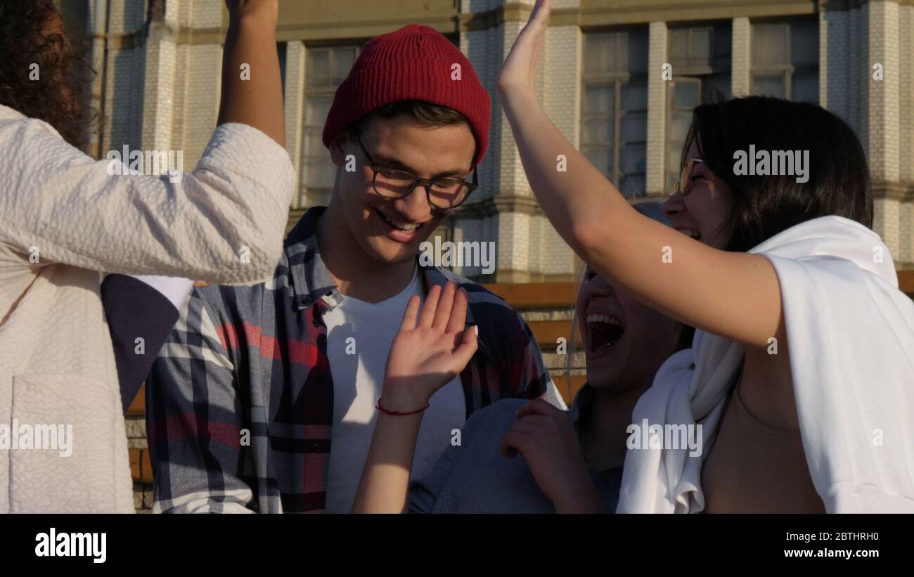 Multicultural cheerful friends giving high five gesture feel exc Stock ...