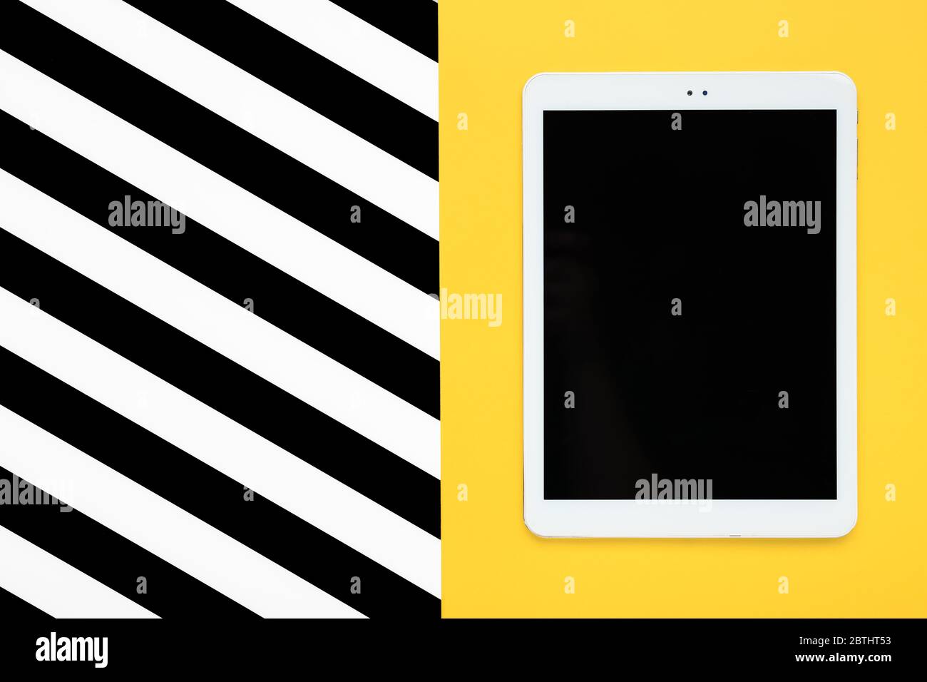 digital tablet with black touch screen display on yellow and white ...