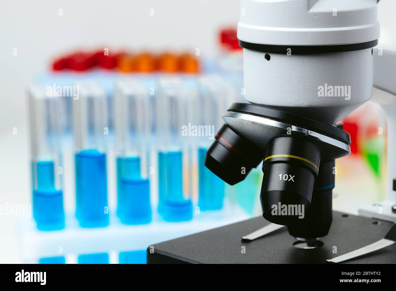 Microscope and test tubes on table in laboratory, close up Stock Photo ...