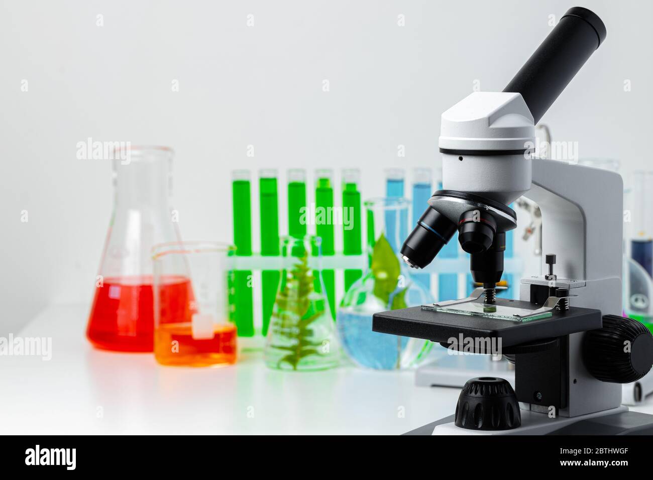 Medical laboratory. Scientific microscope with test tubes and plants ...