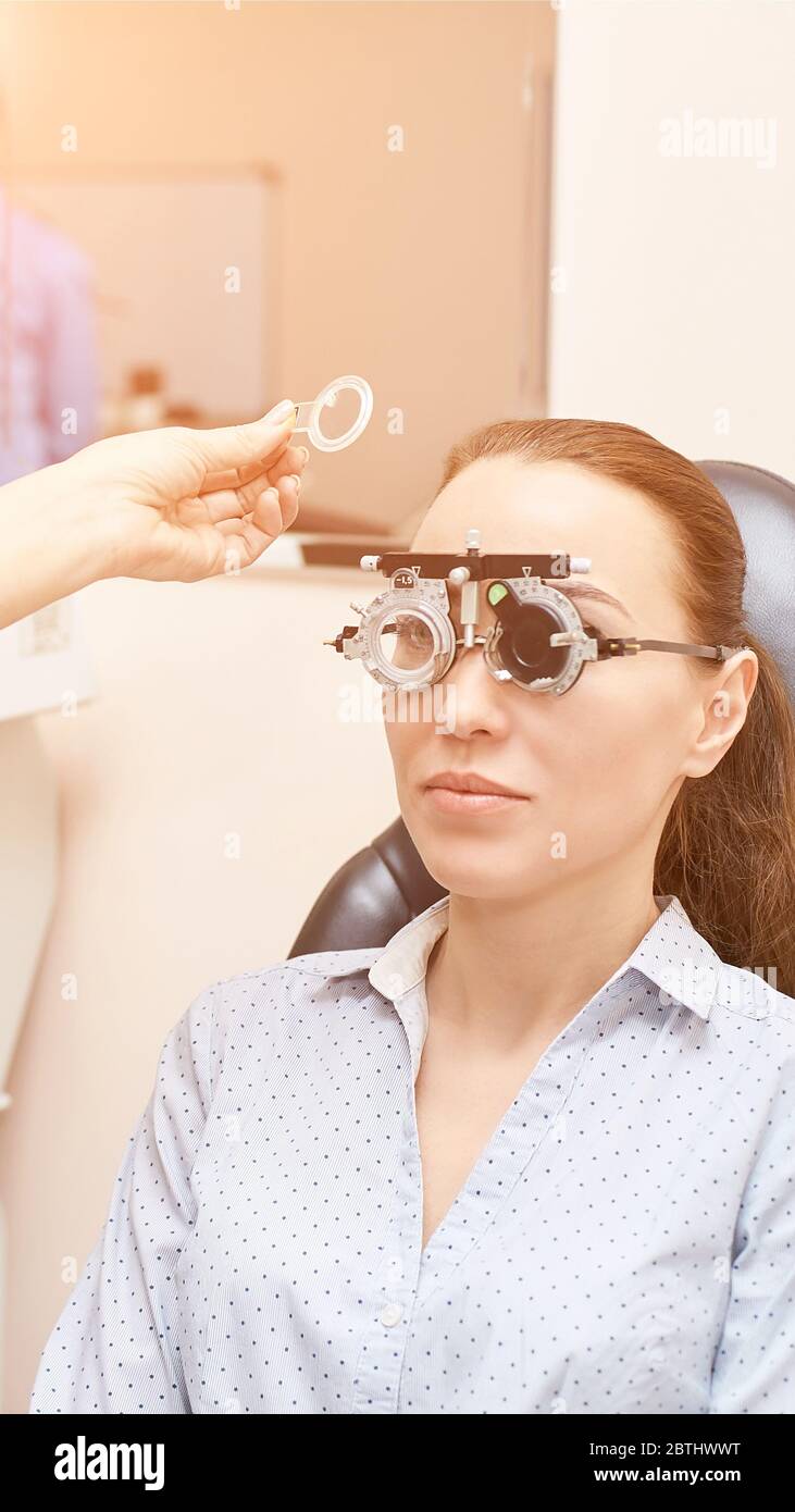 ophthalmologist doctor in exam optician laboratory with female patient ...