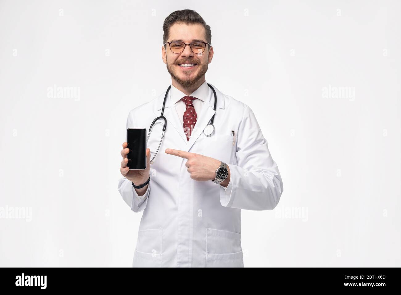 Smiling medical doctor. Isolated over white background Stock Photo - Alamy