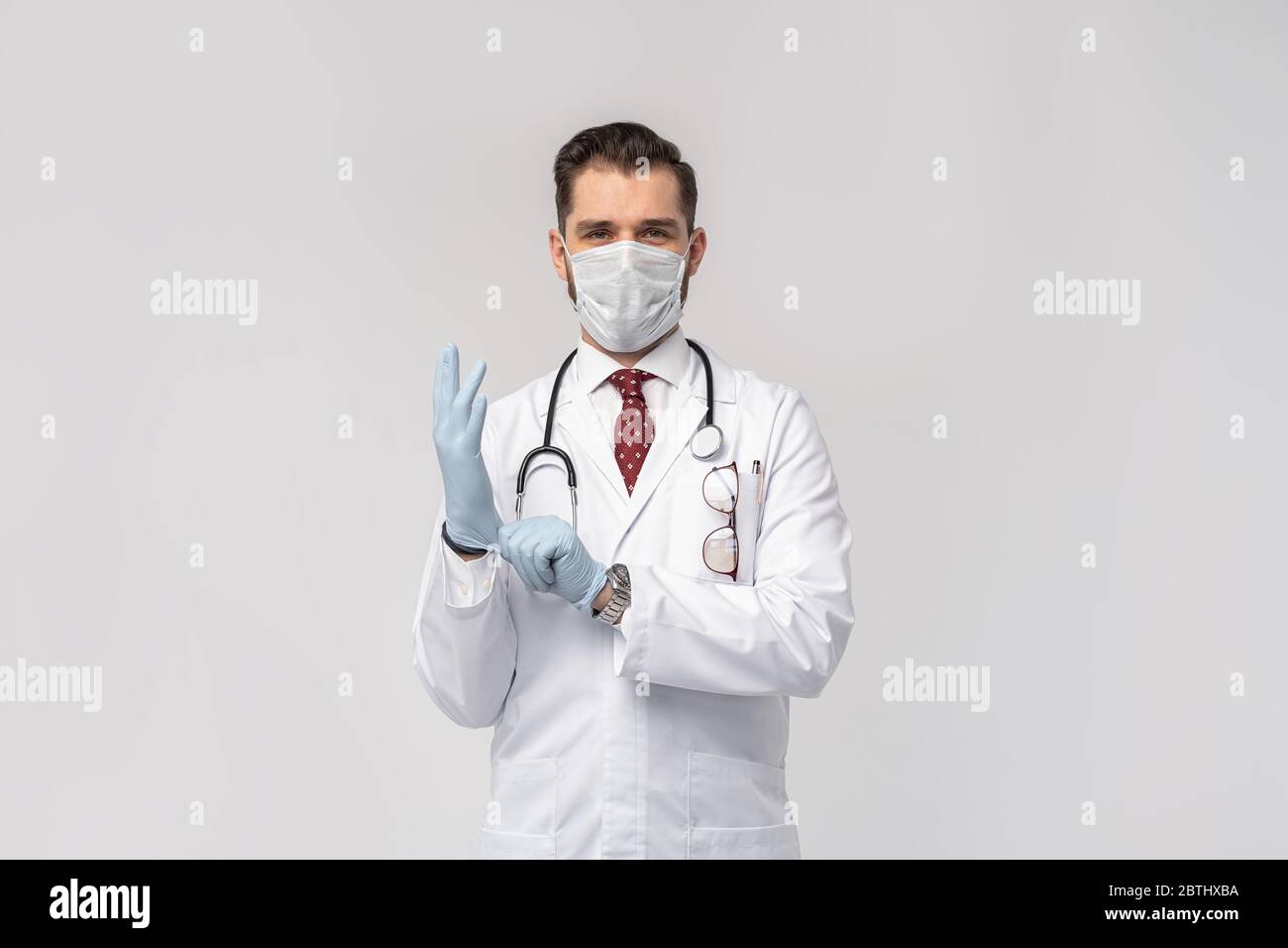 Coronavirus. COVID-19 pandemic. Attractive handsome doctor in ...