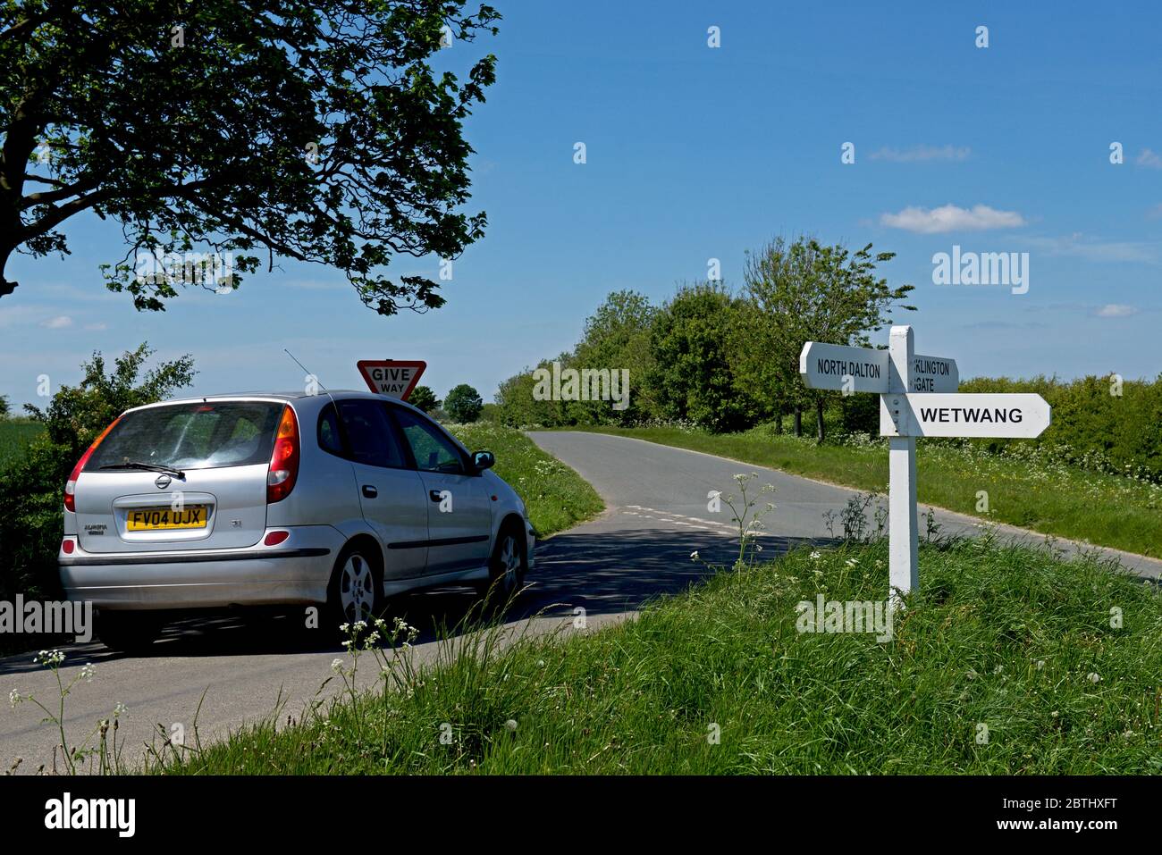 Car passing road sign - Wetwang - on minor road near Huggate, Yorkshire ...