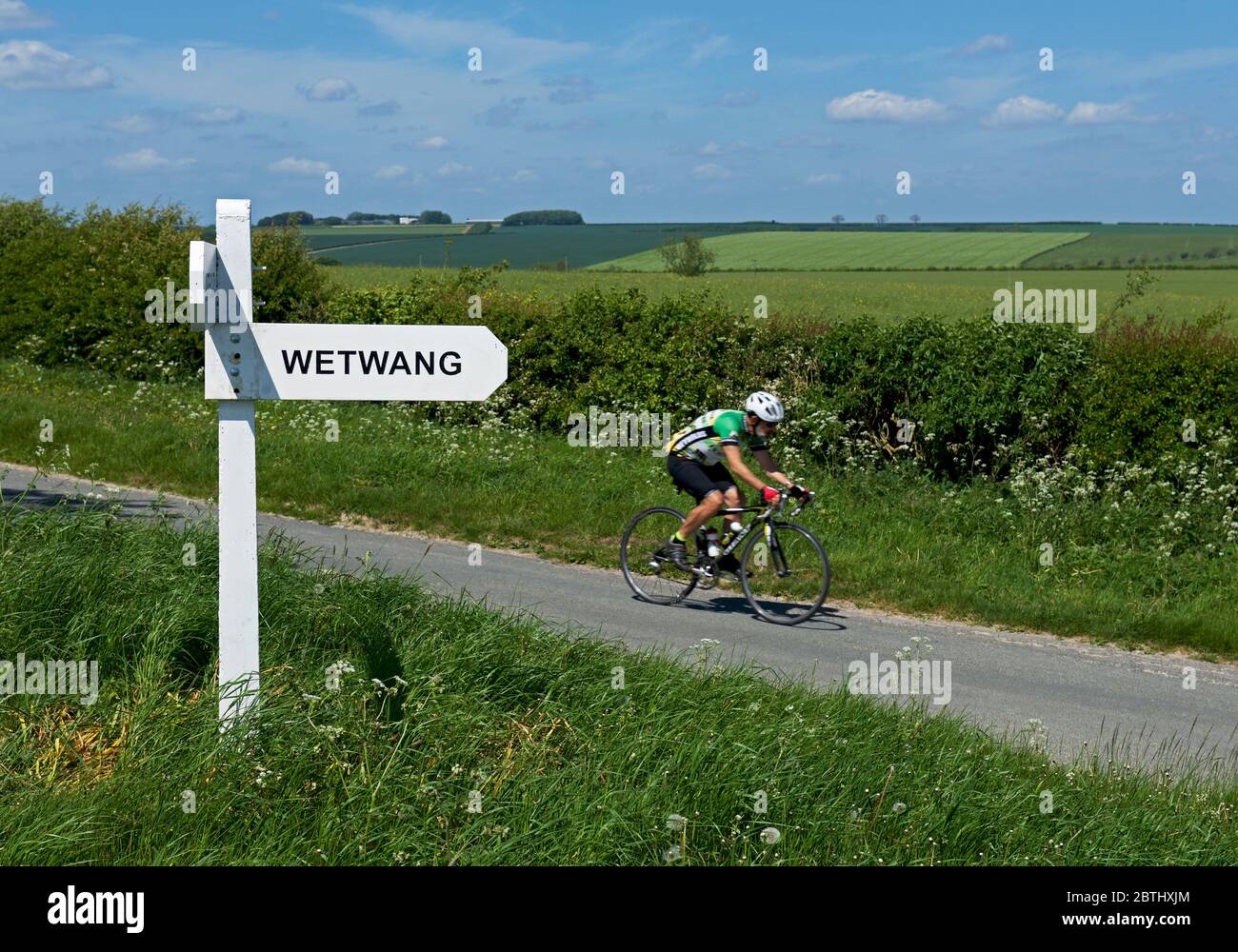 Cyclist passing road sign - Wetwang - on minor road near Huggate ...