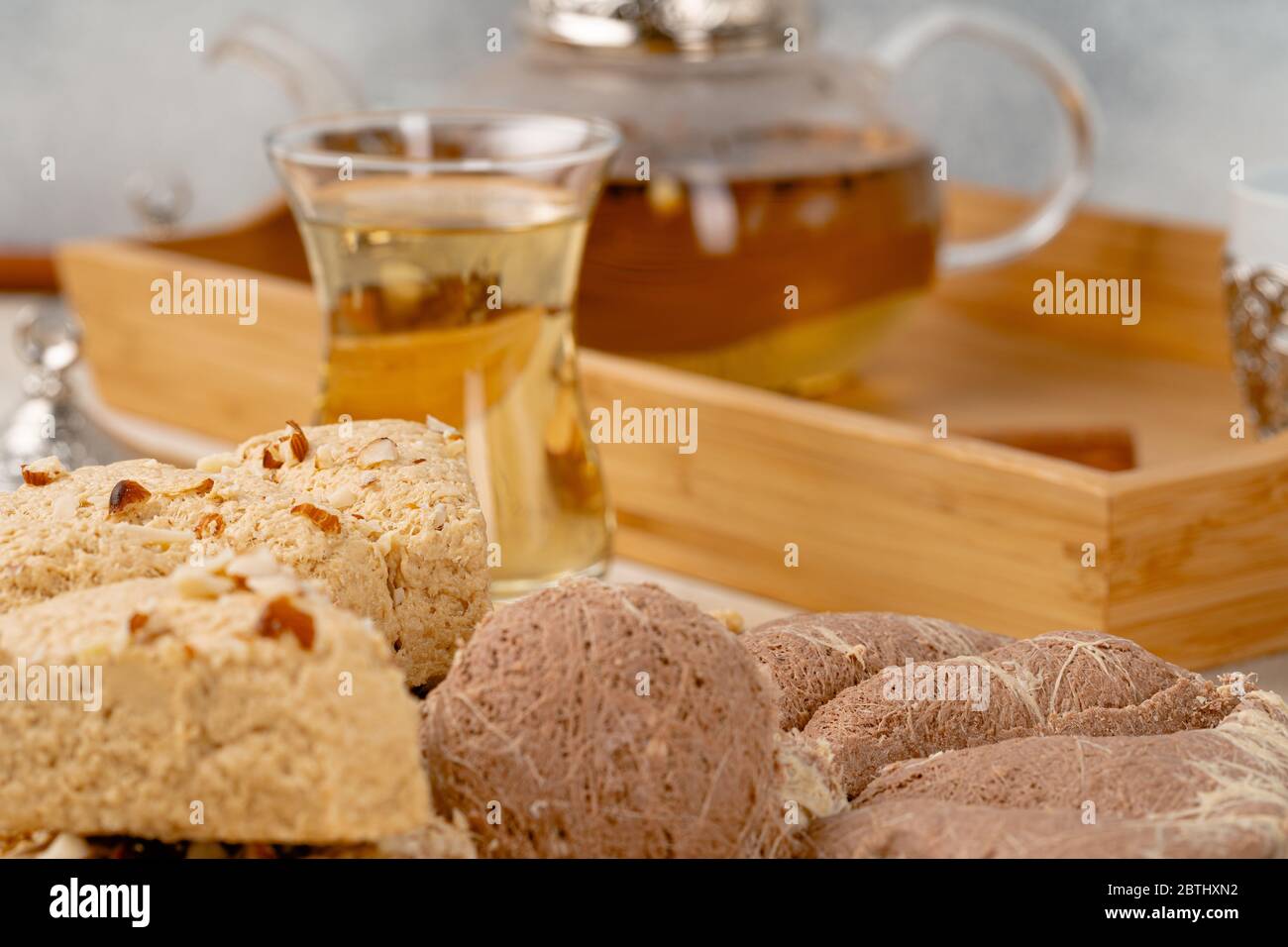 Turkish halva with tea in a glass cup close up Stock Photo - Alamy