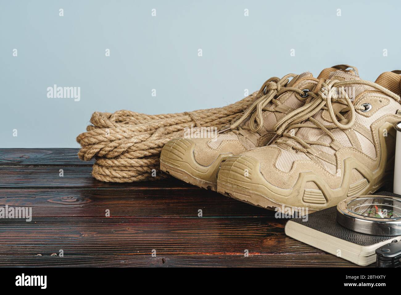 Hiking boots and rope hank on wooden board Stock Photo - Alamy