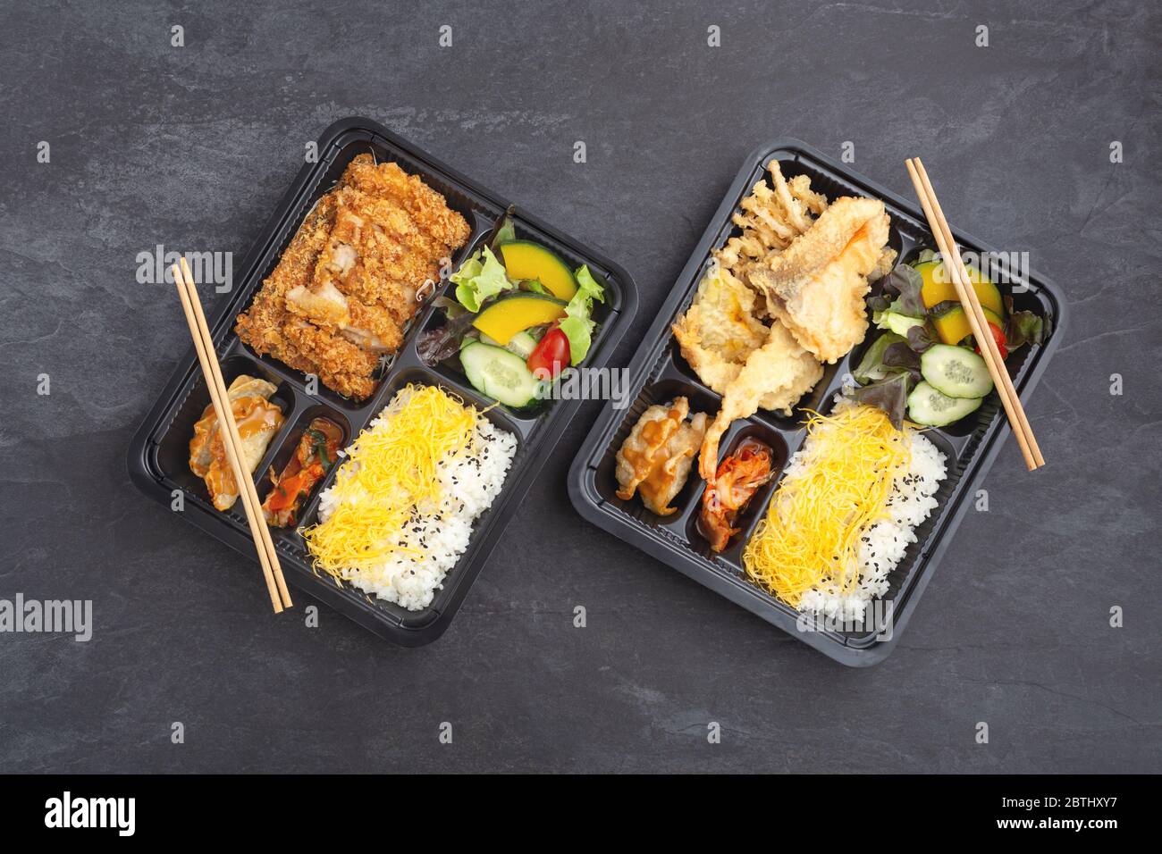 Japanese food bento set with tonkatsu and tempura on dark stone ...