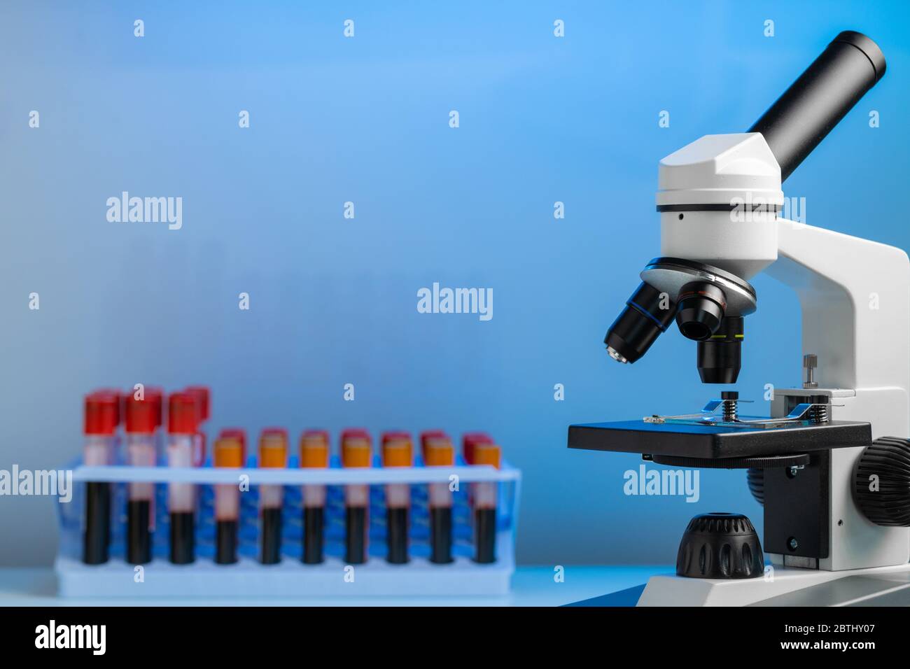 Laboratory microscope with colorful test tubes close up Stock Photo - Alamy