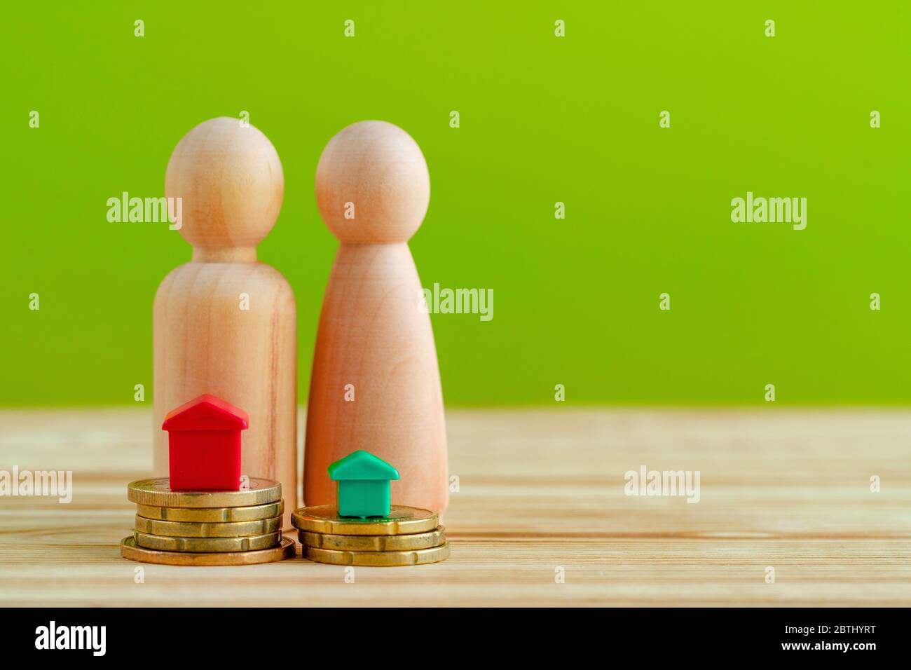 Wooden family with toy house and stack of coins. Savings for house ...