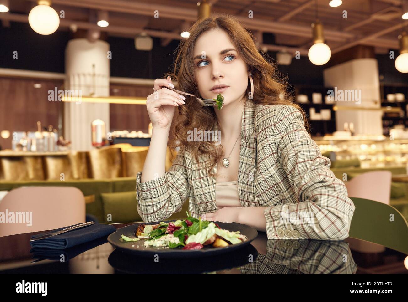 Portrait of young beautiful smiling woman eating healthy food in the ...