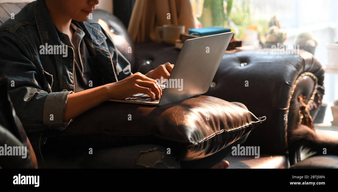 Photo of attractive man in denim shirt working/typing on computer ...