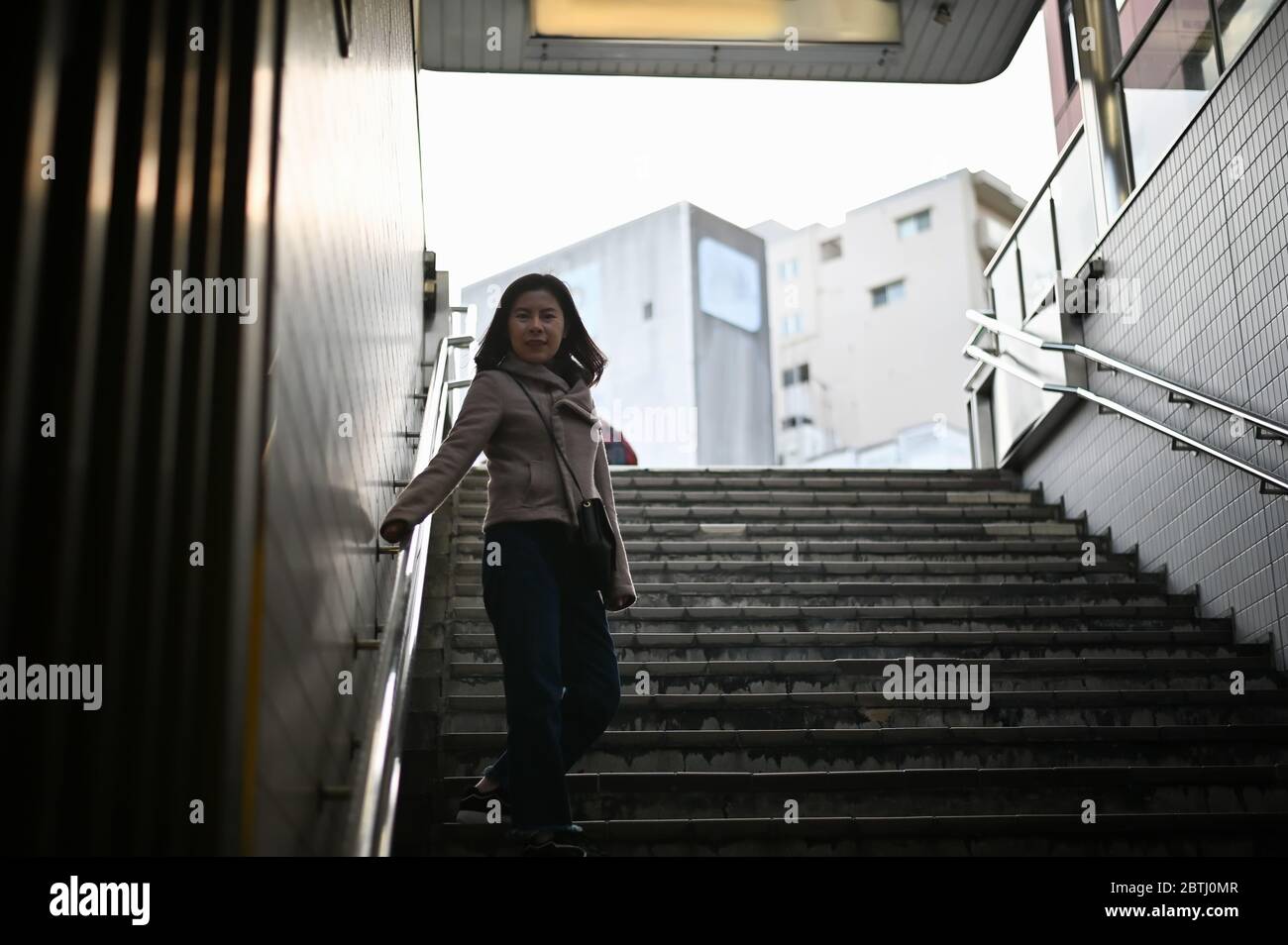 Traveller female funny moment on stair metro train in Japan Stock Photo ...
