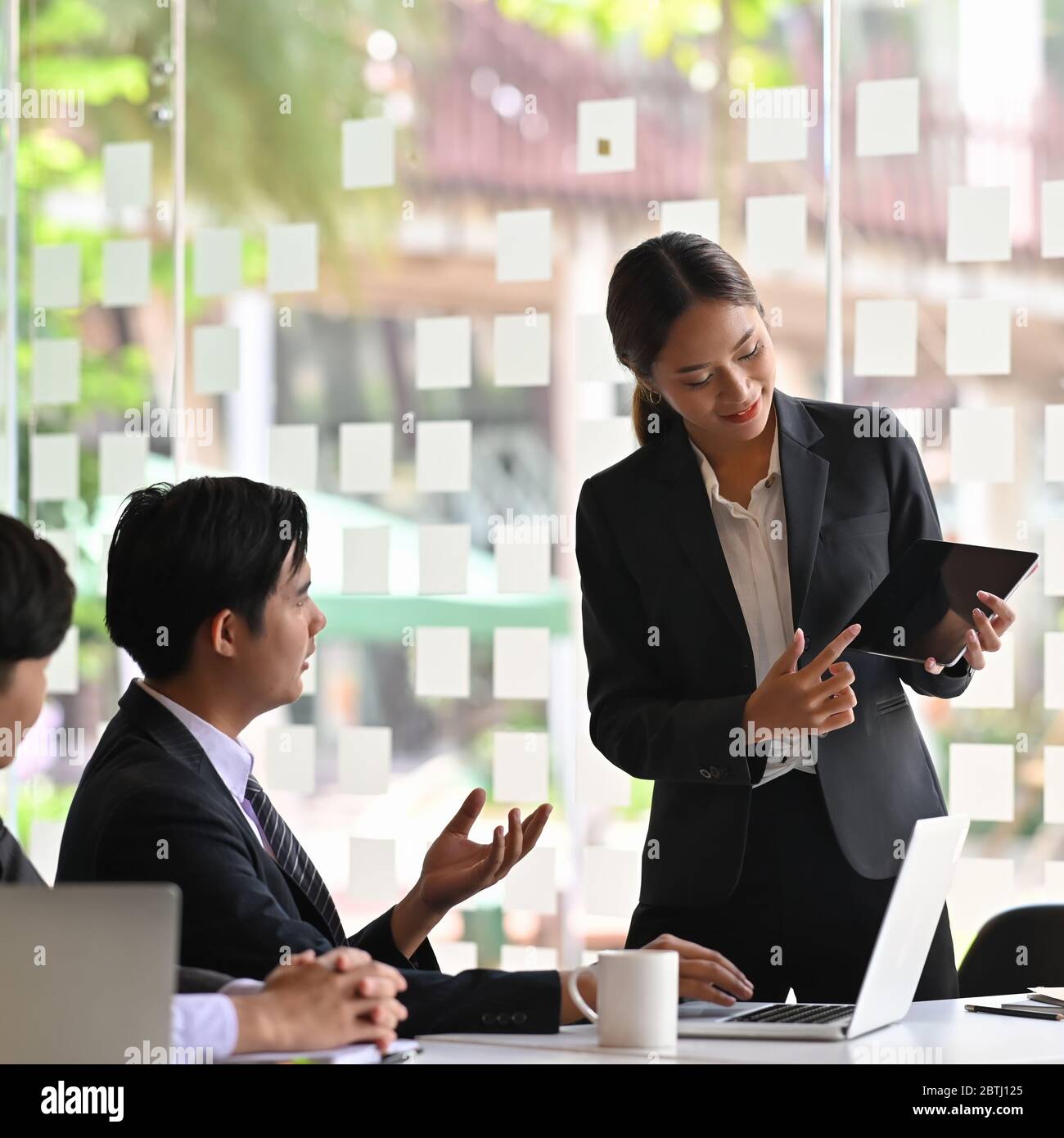 Business developer team meeting/working while sitting and standing ...