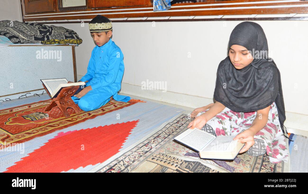 Muslim children read the holy Quran as they offer namaz on Jumat-Ul ...