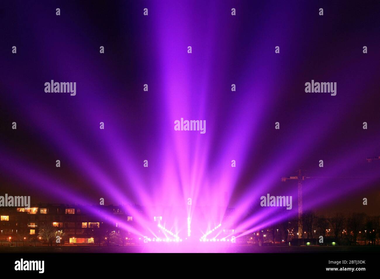 light beams in the night on the city promenade. Festive illumination ...