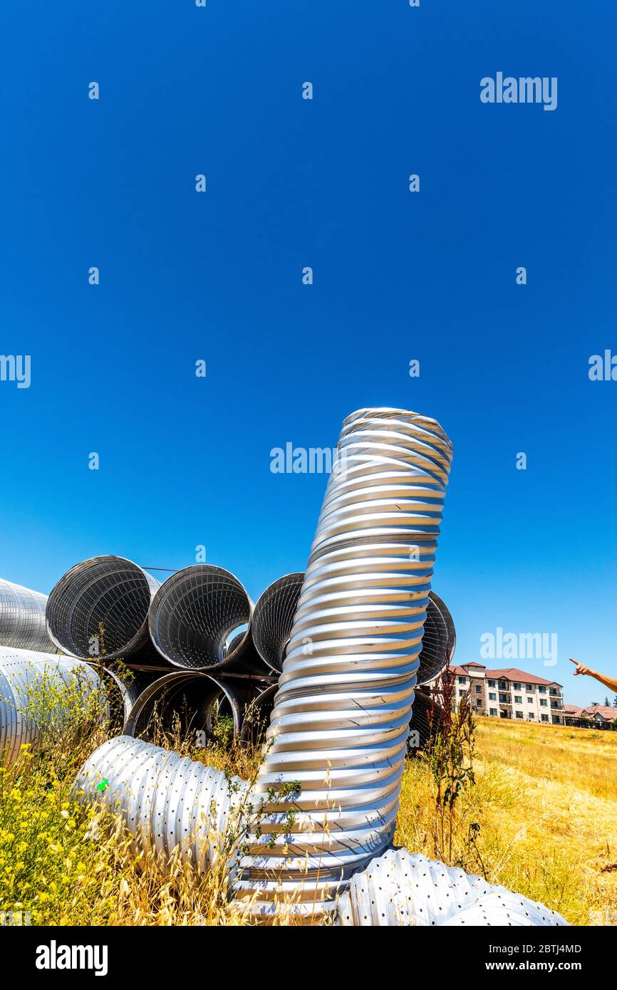 Perforated culvert stacked for use at a construction site in Modesto ...