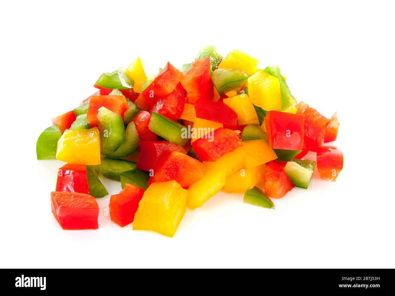 Pile of chopped fresh paprika in several colors over white background ...