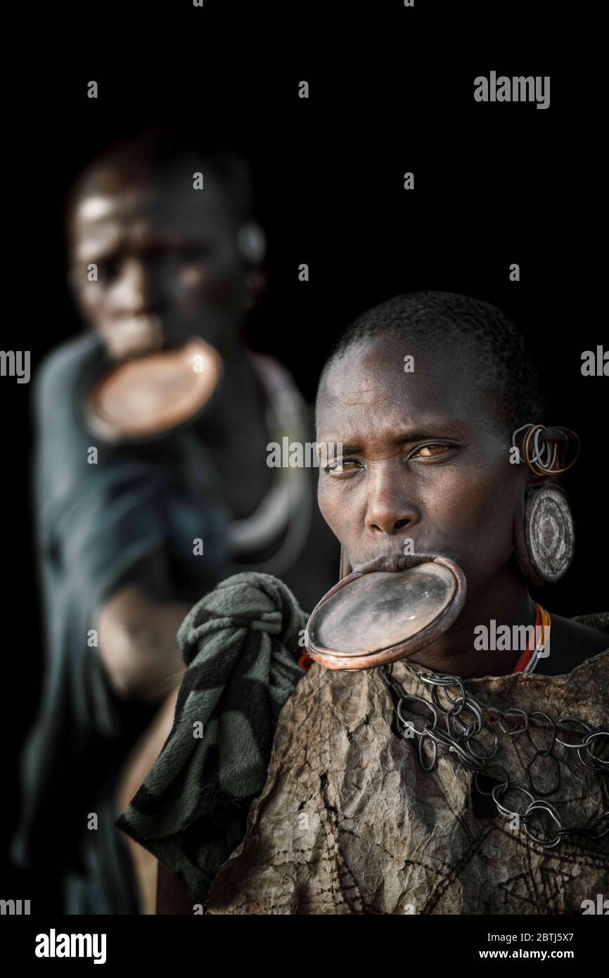 Two tribes people with clay plates in their mouths. LONDONDERRY ...