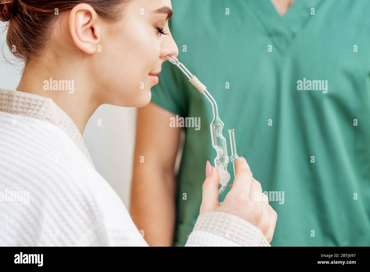 Young woman is receiving essential oil nasal inhaler in medical spa ...