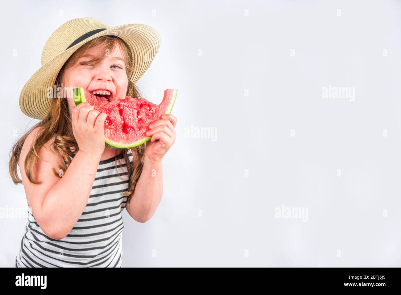 Happy little child with watermelon. Smiling kid girl eating watermelon ...