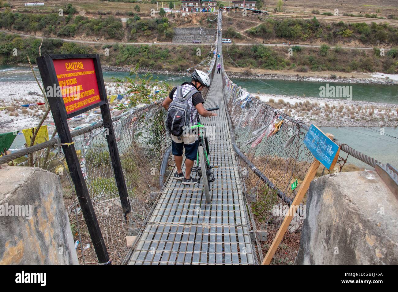 Bhutan, Punakha. Punakha Suspension Bridge, draped in prayer flags ...