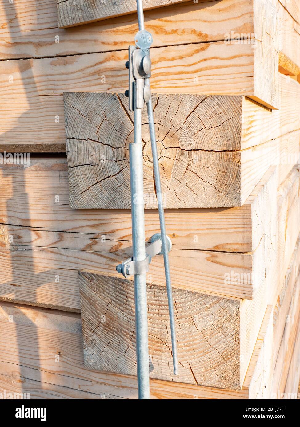 Log wall of modern wooden house under construction. Detail of lightning ...