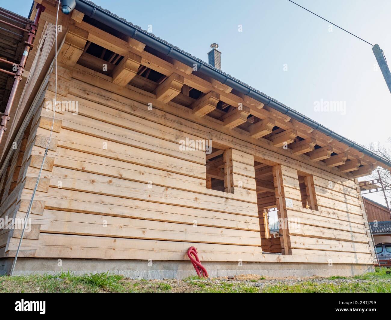 Wooden logs and beams house under wooden roofing construction ...