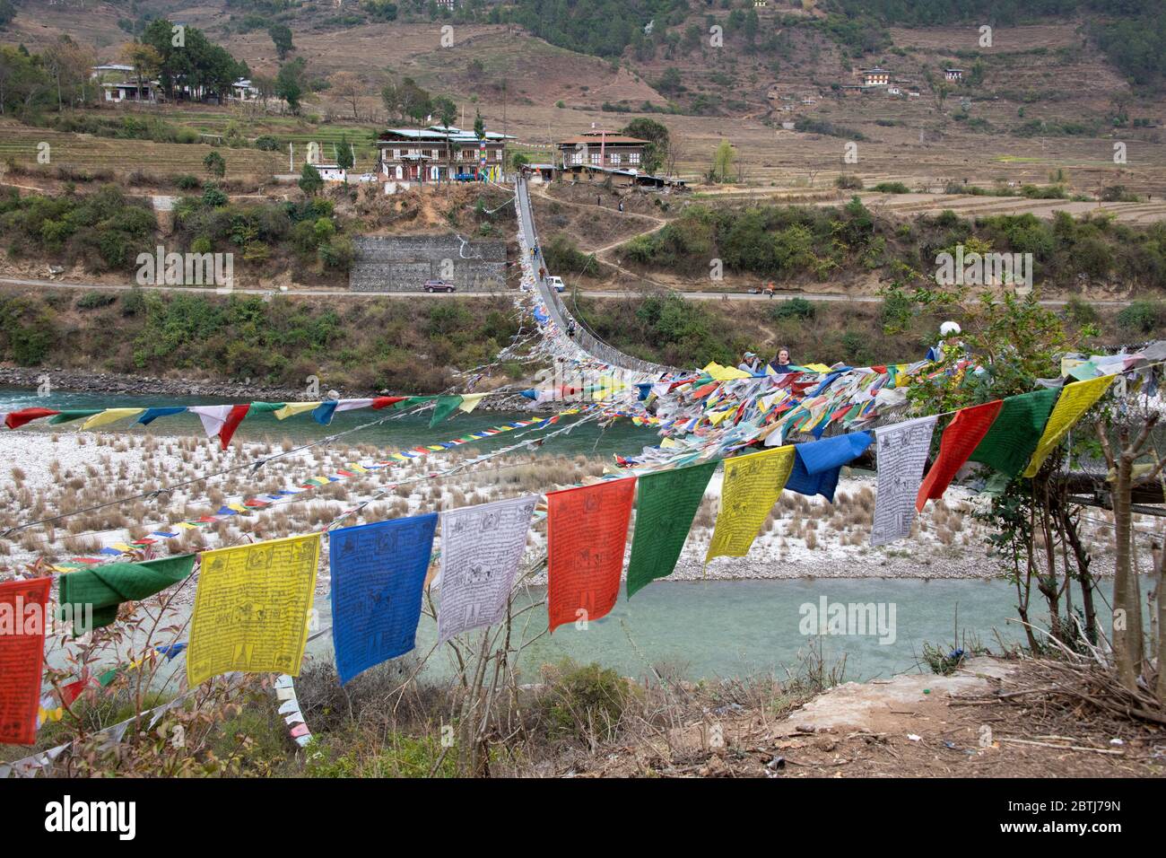 Bhutan, Punakha. Punakha Suspension Bridge, draped in prayer flags ...