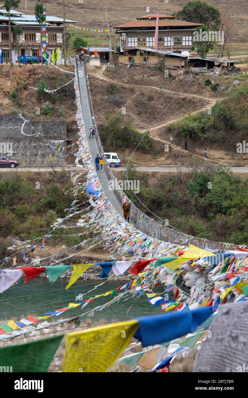 Bhutan, Punakha. Punakha Suspension Bridge, draped in prayer flags ...