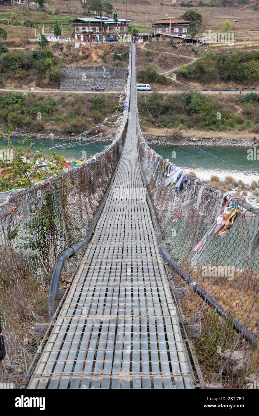 Bhutan, Punakha. Punakha Suspension Bridge, draped in prayer flags ...